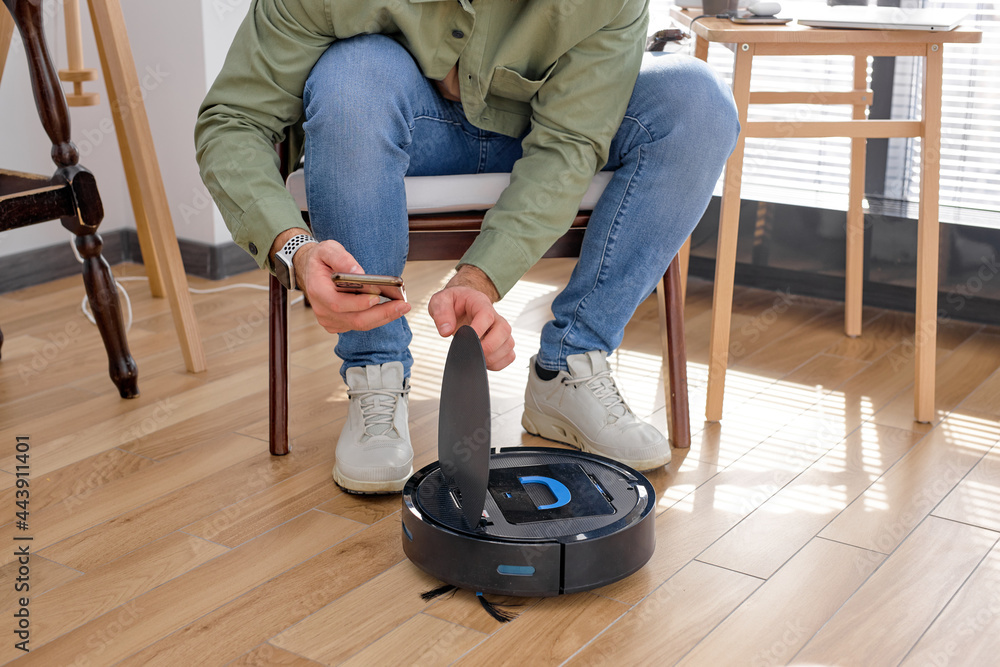 Robot vacuum cleaning on laminate wood floor. innovation artificial ...