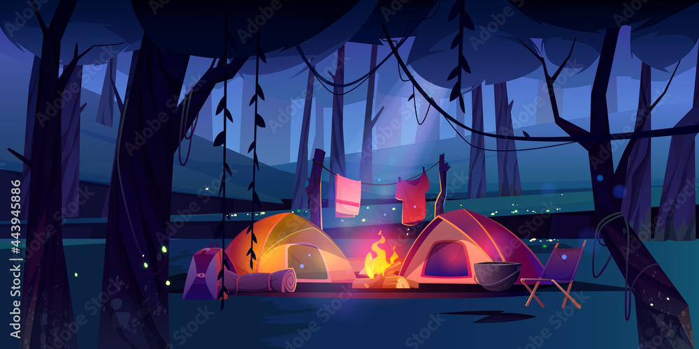 Night camping with tents, campfire and tourist stuff in dark forest ...