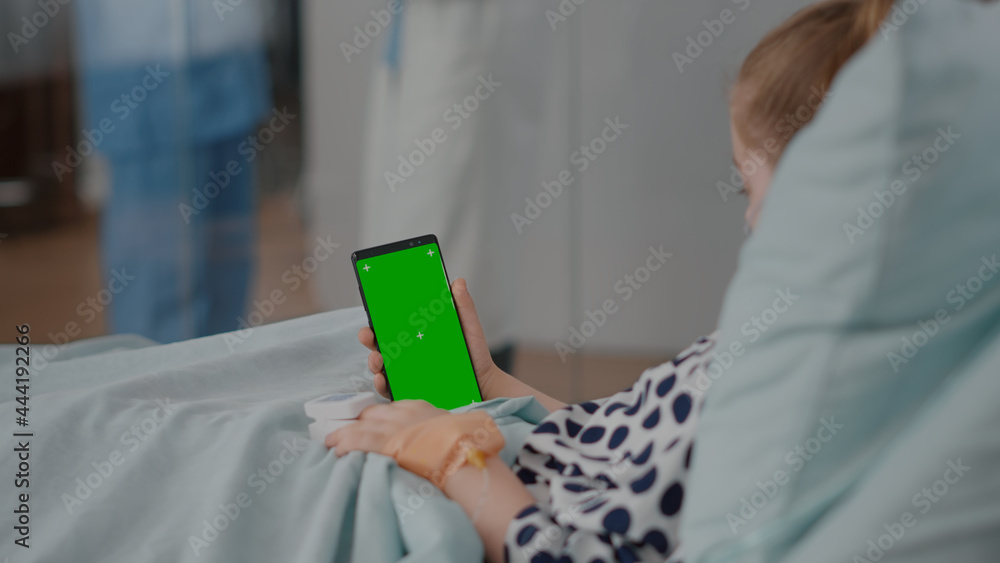Little kid holding mock up green screen chroma key phone with isolated ...