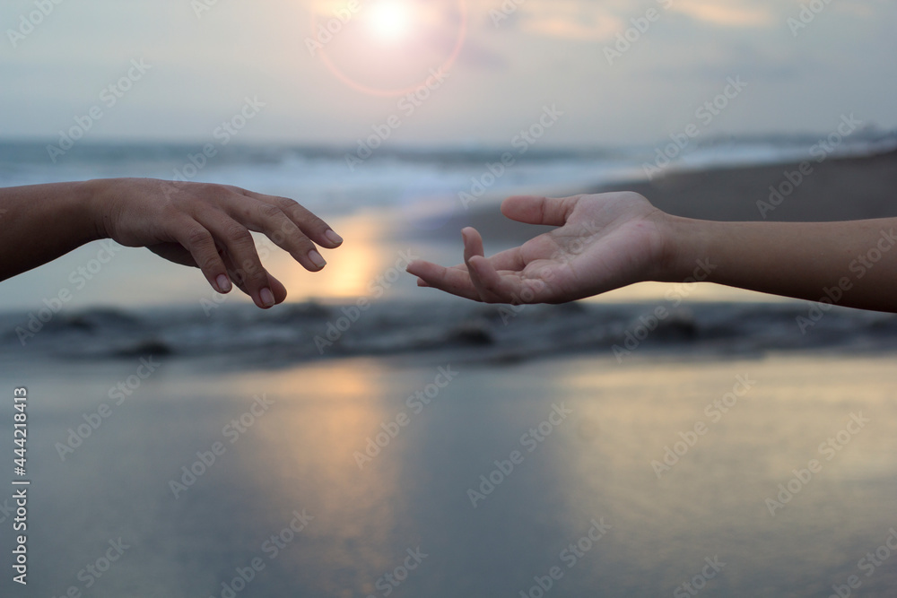 Two People Reaching For Each Other