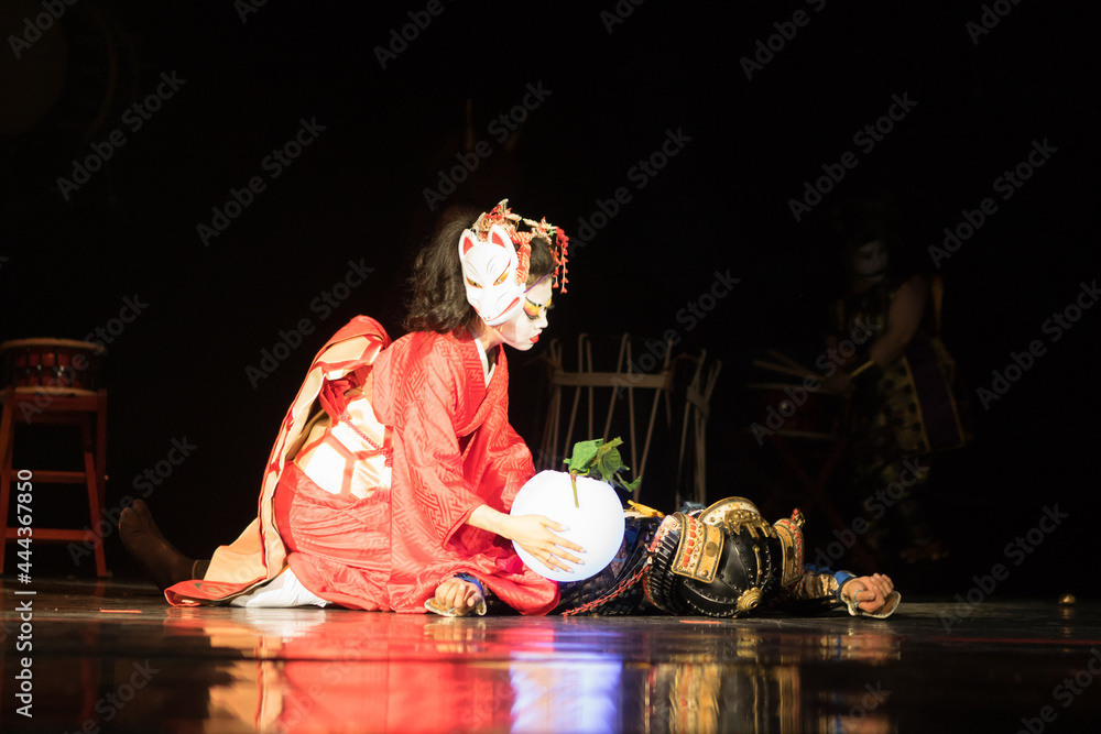 Japanese woman mourns a dead samurai sitting on her knees with a lamp ...