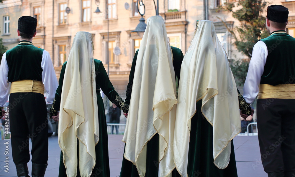 Group of Polish Tatars women and men in traditional costumes stand on ...