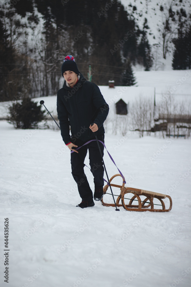 Horal pulls to top of wooden sled for a ride on the piste. Going back ...