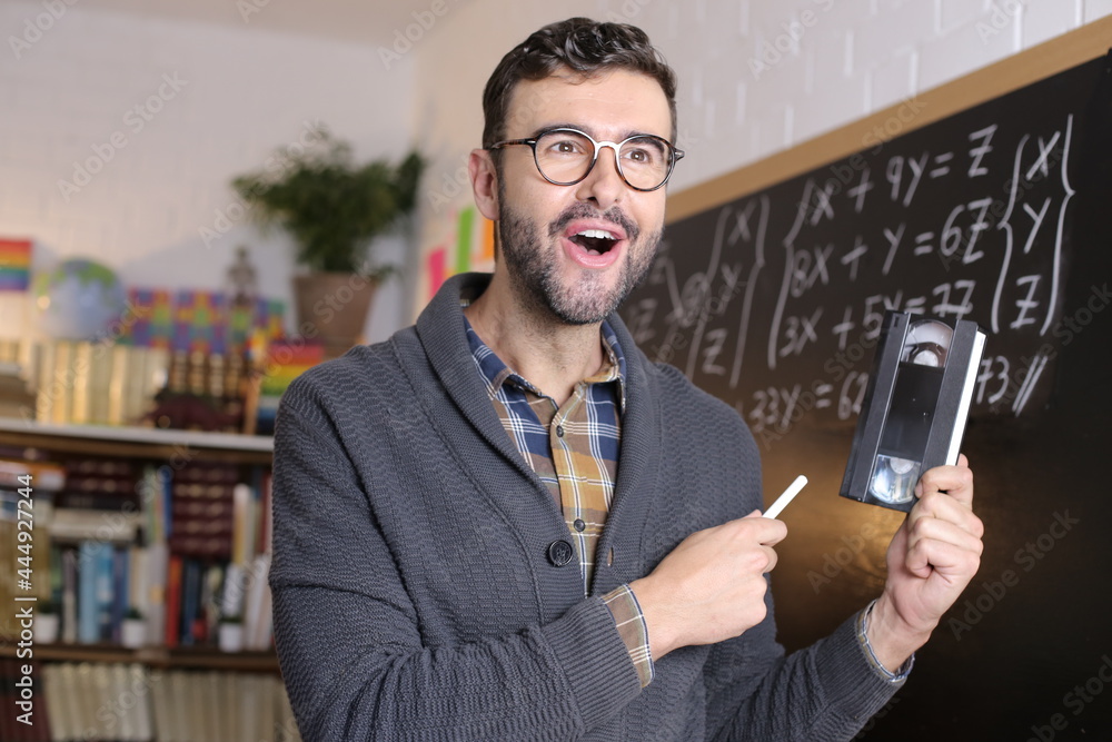 1980s teacher holding VHS tape in classroom Stock Photo | Adobe Stock