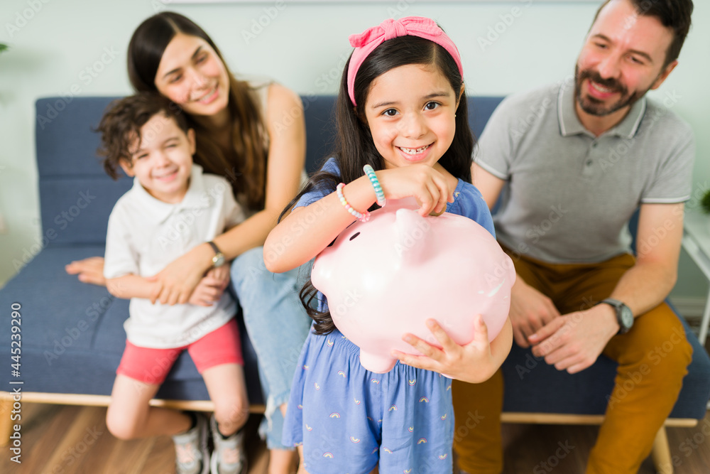 Adorable daughter saving for a family vacation Stock Photo | Adobe Stock