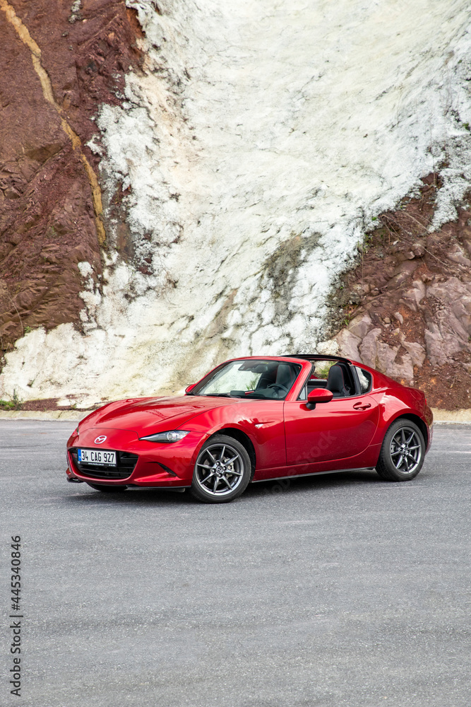 Mazda MX-5, is a lightweight two-seater roadster with a front-engine ...