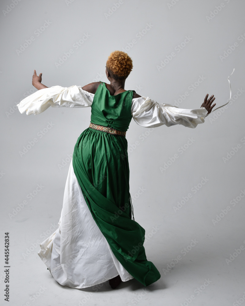Full length portrait of pretty African woman wearing long green ...