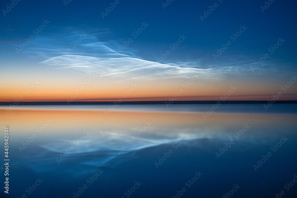 Noctilucent clouds on the background of the night sky with reflection ...