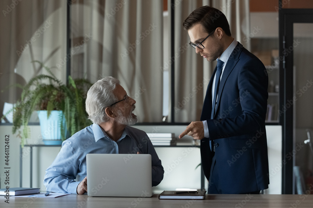 Stock-Foto „Annoyed angry boss scolding senior 60s employee for mistake ...