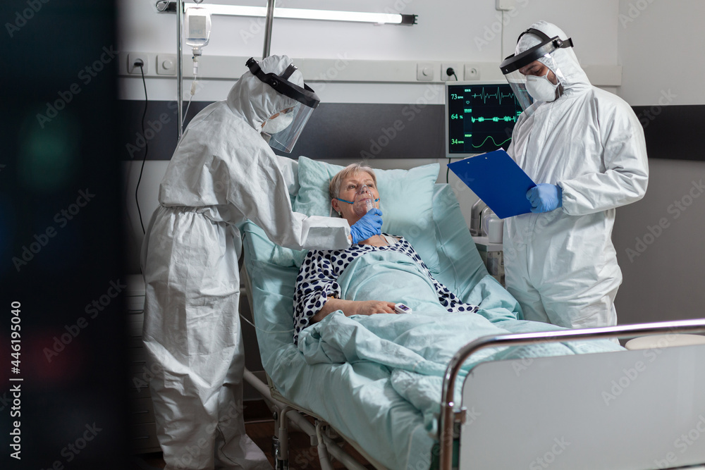 Doctor and nurse wearing cover all ppe suit as prevention for infection ...
