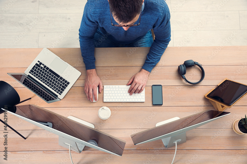 Programmer working at desk in office, top view Stock Photo | Adobe Stock