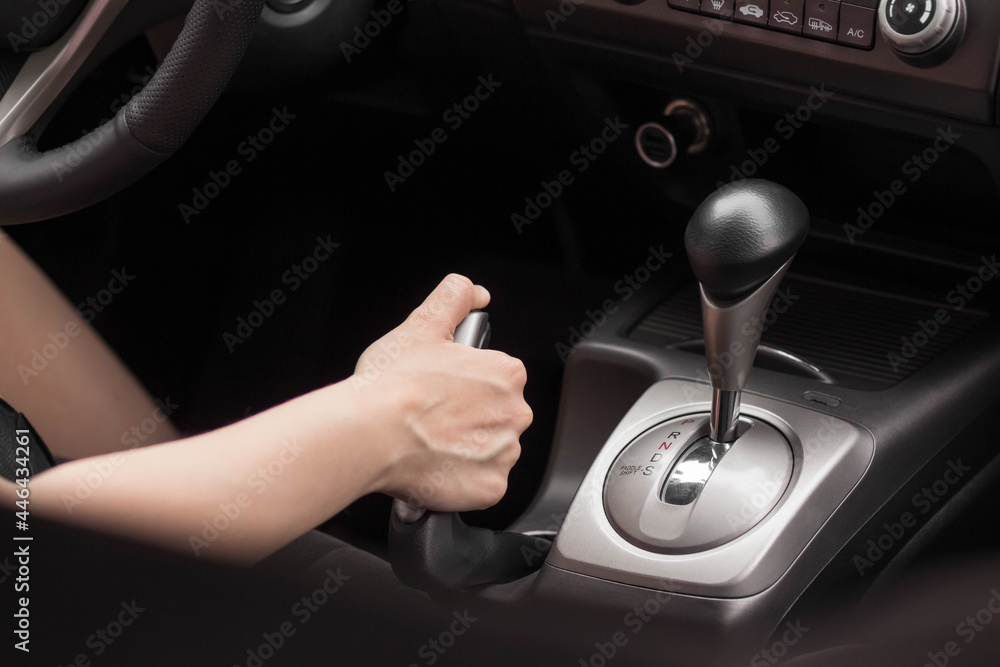 Driver pulling the hand brake in car. Close up Stock Photo | Adobe Stock