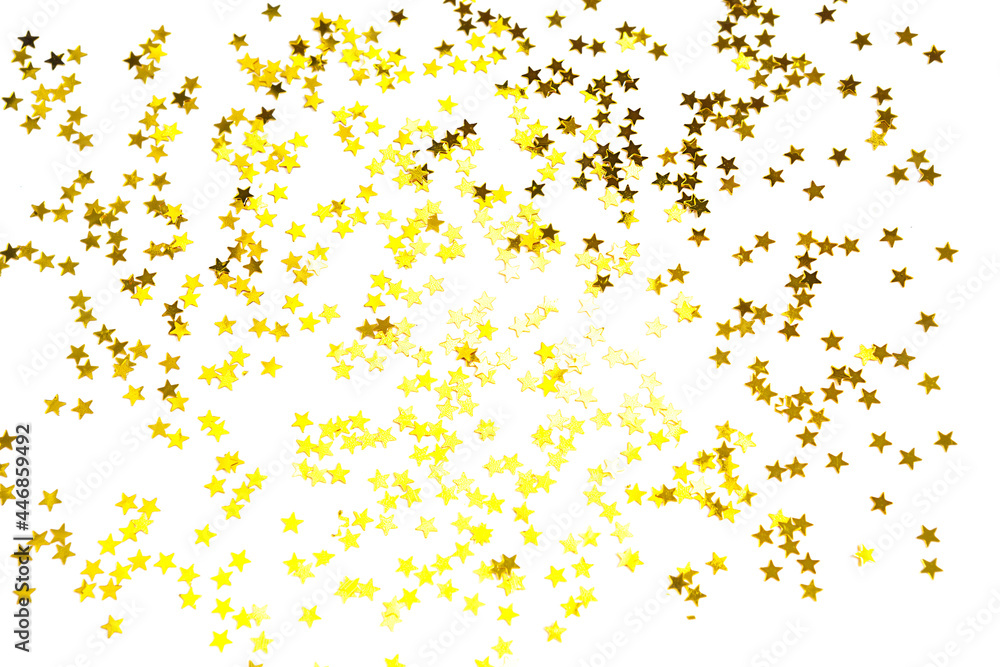 Gold sequins in the shape of stars shimmer on a white background ...