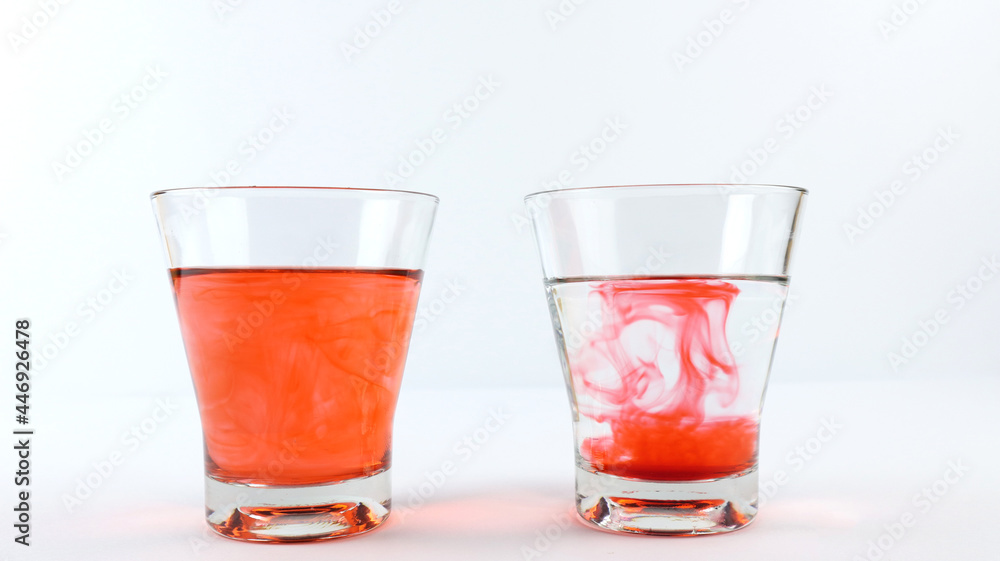 Diffusion of colors in a glass filled with water and another glass ...