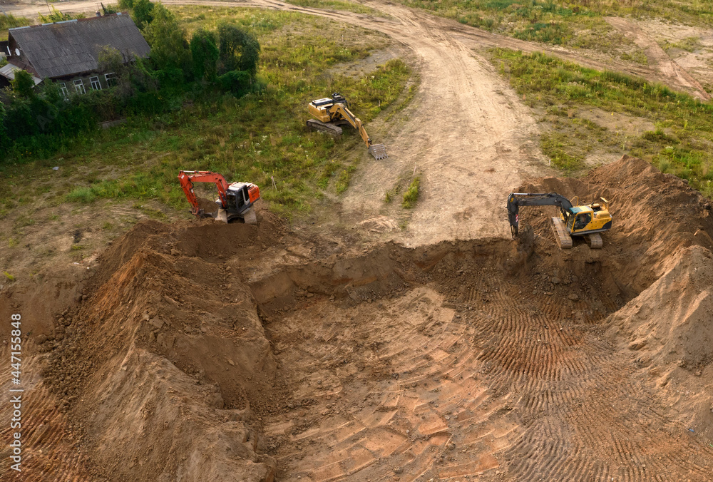 Excavator dig ground at a construction site. Trench for laying external ...