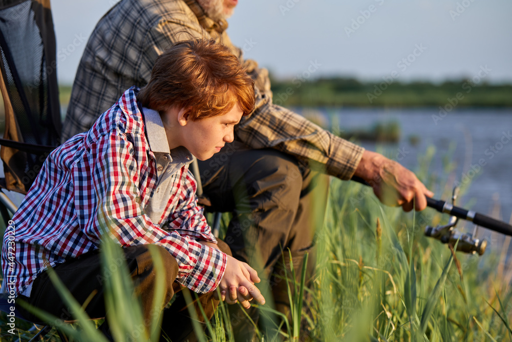 Fishing for pike, perch, carp. Skilled elderly Fisherman and kid boy ...