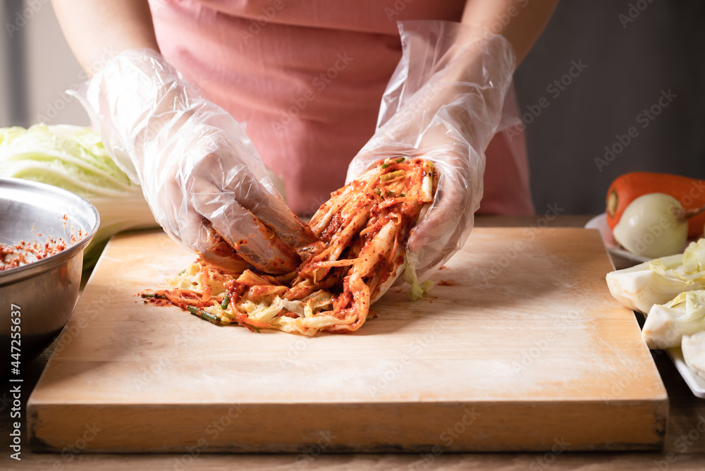 Woman making kimchi cabbage on wooden board, Popular homemade Korean ...