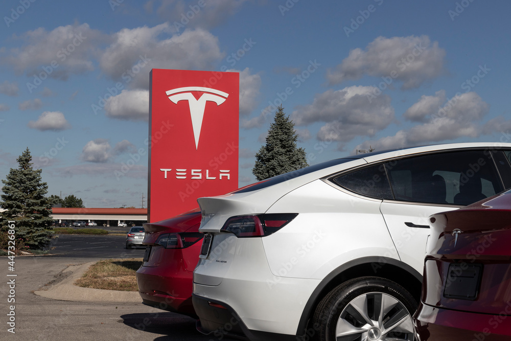 Tesla electric vehicles awaiting preparation for sale. Tesla EV Model 3 ...