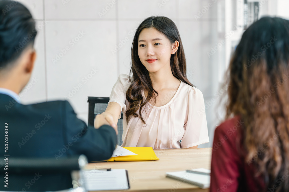 Young Asian woman graduate hand shake with two manager to welcome ...