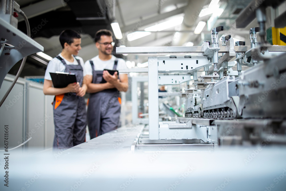 Foto de Stock Production line workers controlling manufacturing process ...