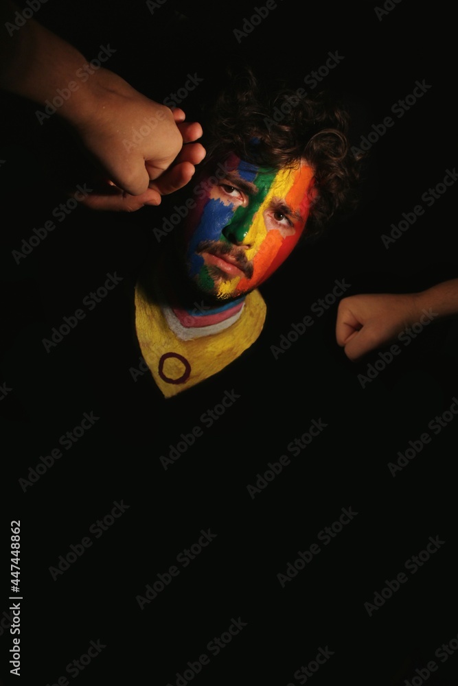 Portrait of young man painted as lgbtq progress pride flag fighting ...