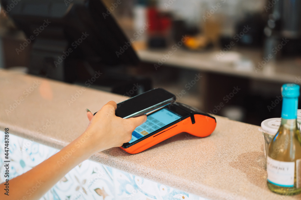 Contactless payment from the phone through the pos terminal Stock Photo ...