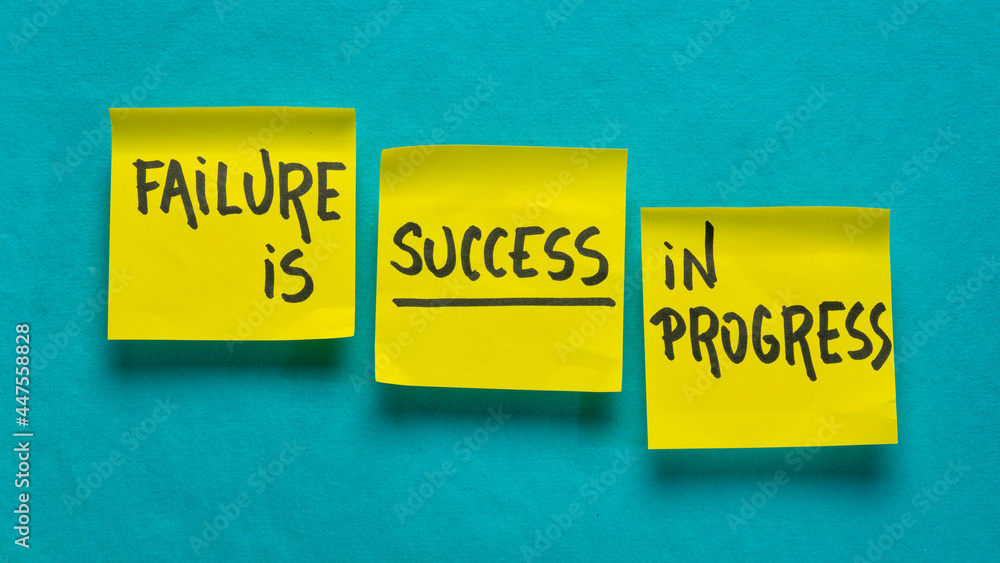 Failure is success in progress - inspirational handwriting on a yellow ...