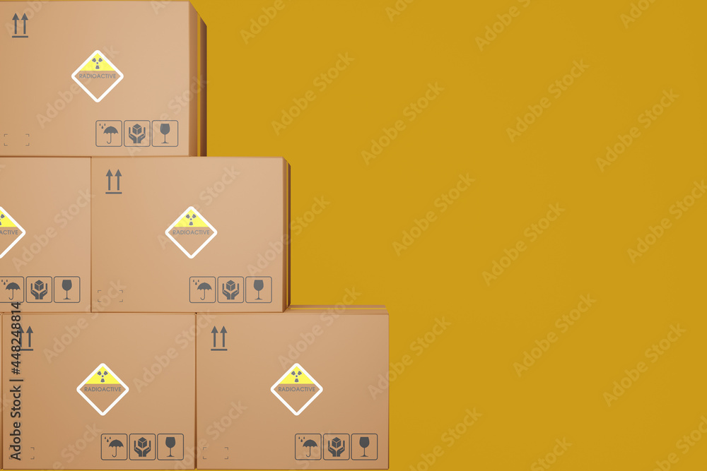 Dangerous goods, cardboard boxes labeled Radioactive on a yellow-brown ...