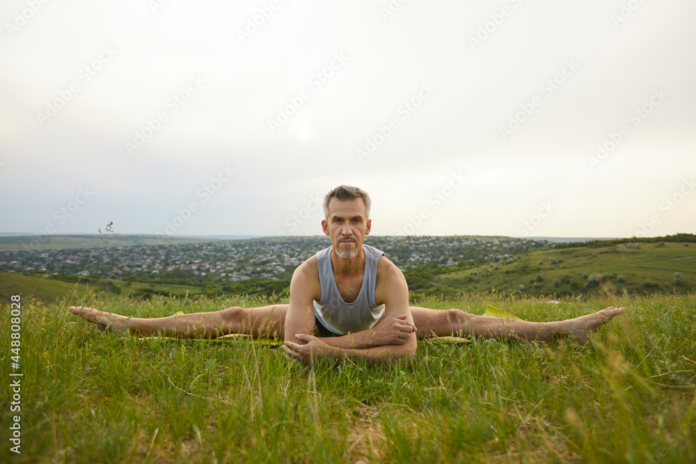 Foto de Stock Serious middle aged male yogi doing Wide Angle Seated ...