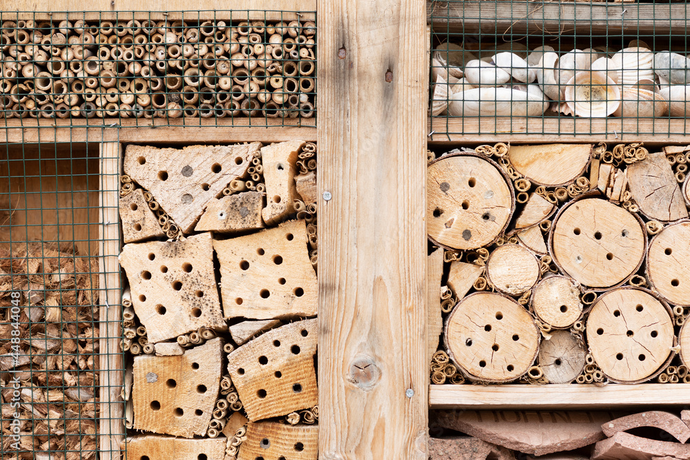 Insect hotel detail made of natural material like wood, branches ...
