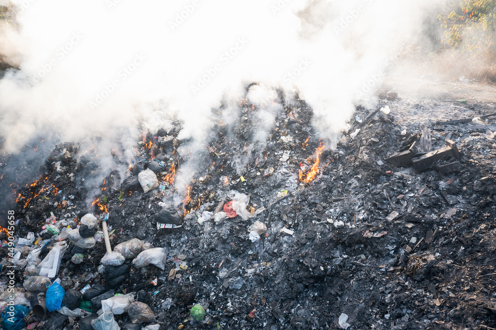 Garbage and fire burn in landfill. Also call trash, waste, rubbish ...
