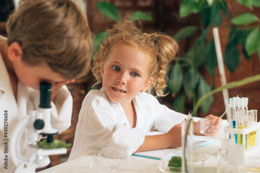 Stock-Foto „Boy and girl in white uniforms and protective glasses do ...