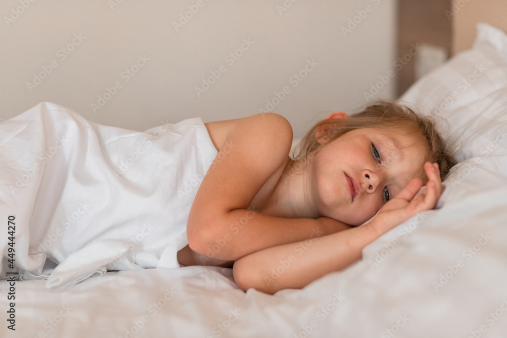 Adorable little girl sleeping in bed with white linens. Place for your ...