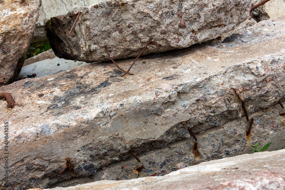 Damaged reinforced concrete blocks and slabs piled on the ground ...