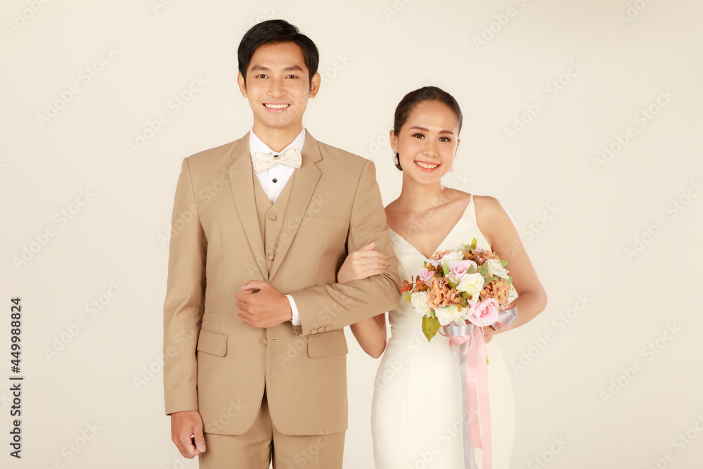 Young attractive Asian couple, bride and groom, woman wearing white ...