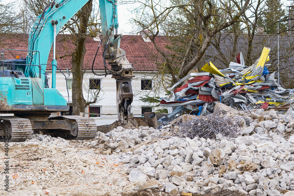 Old stone building demolition with excavator. Excavator working on ...