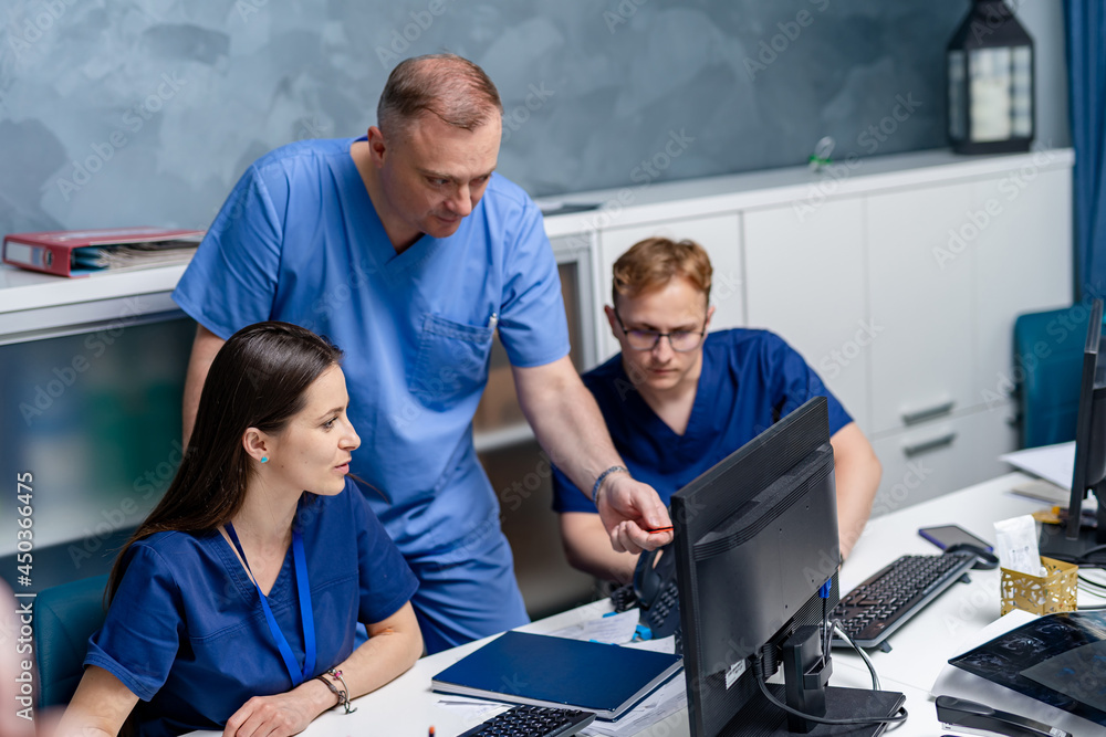 Medical team posing over medical office background while working with ...