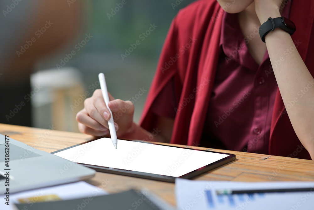 Closed up with Asian female in red shirt and overcoat using stylus pen ...