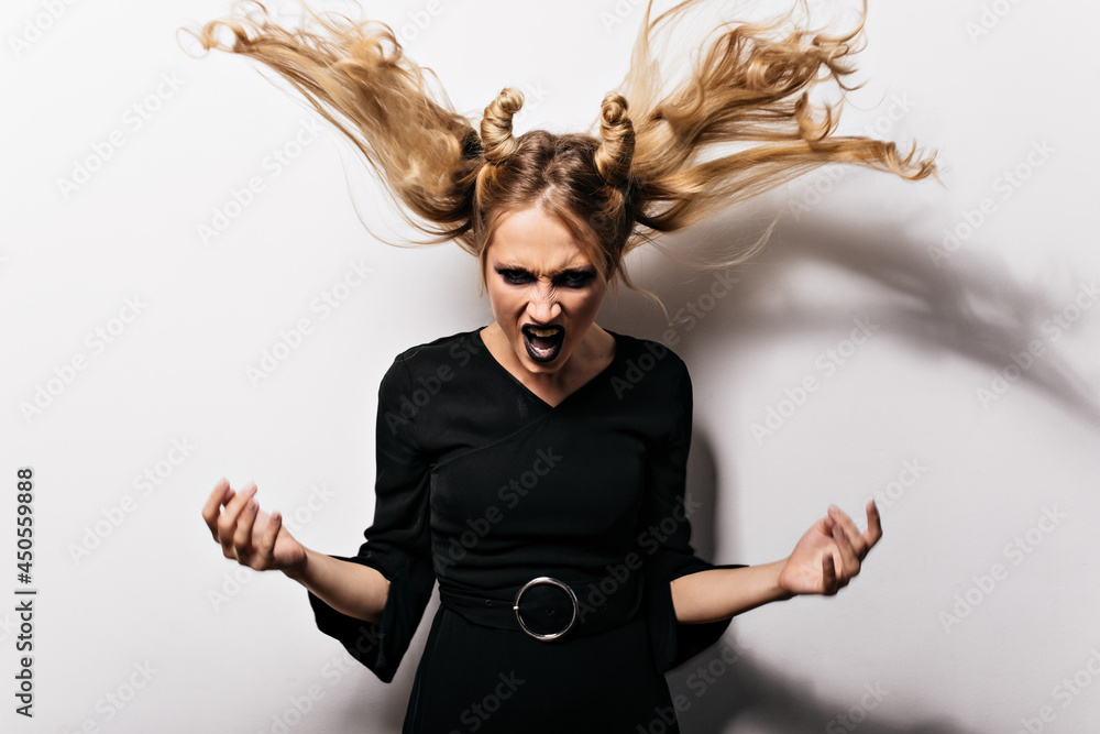 Angry witch with long hair posing in halloween. Evil vampire girl ...