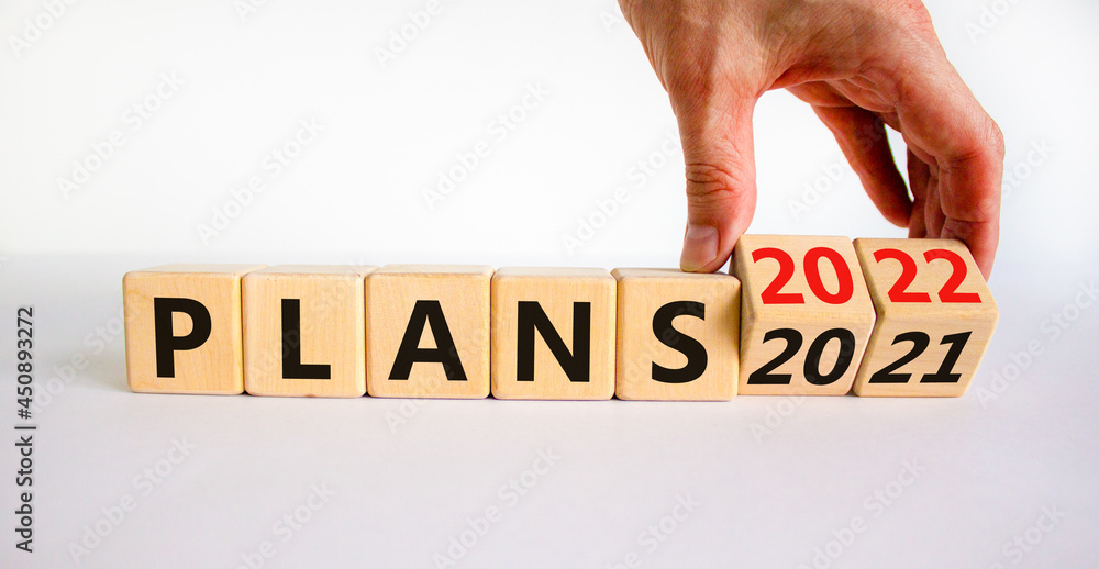 2022 plans new year symbol. Businessman turns wooden cubes and changes ...