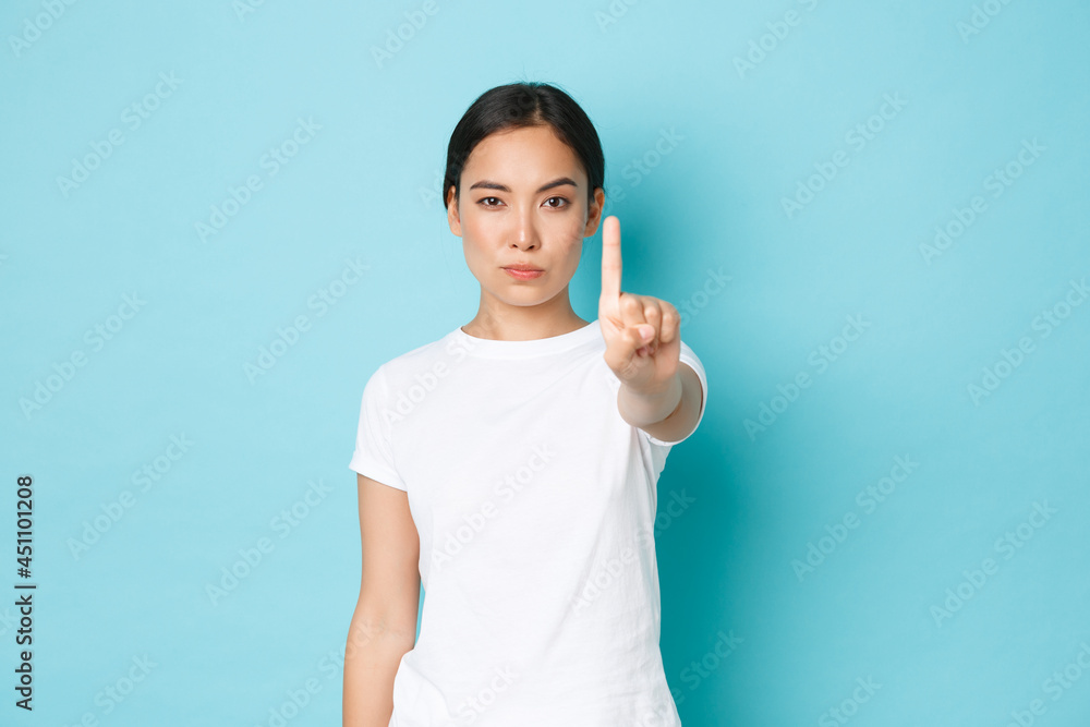 Serious-looking assertive young asian woman forbid action, express ...