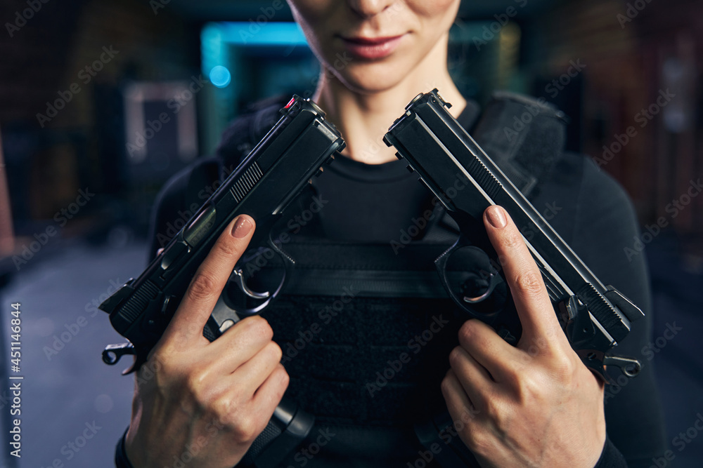 Professional Caucasian female shooter showing her two handguns Stock ...