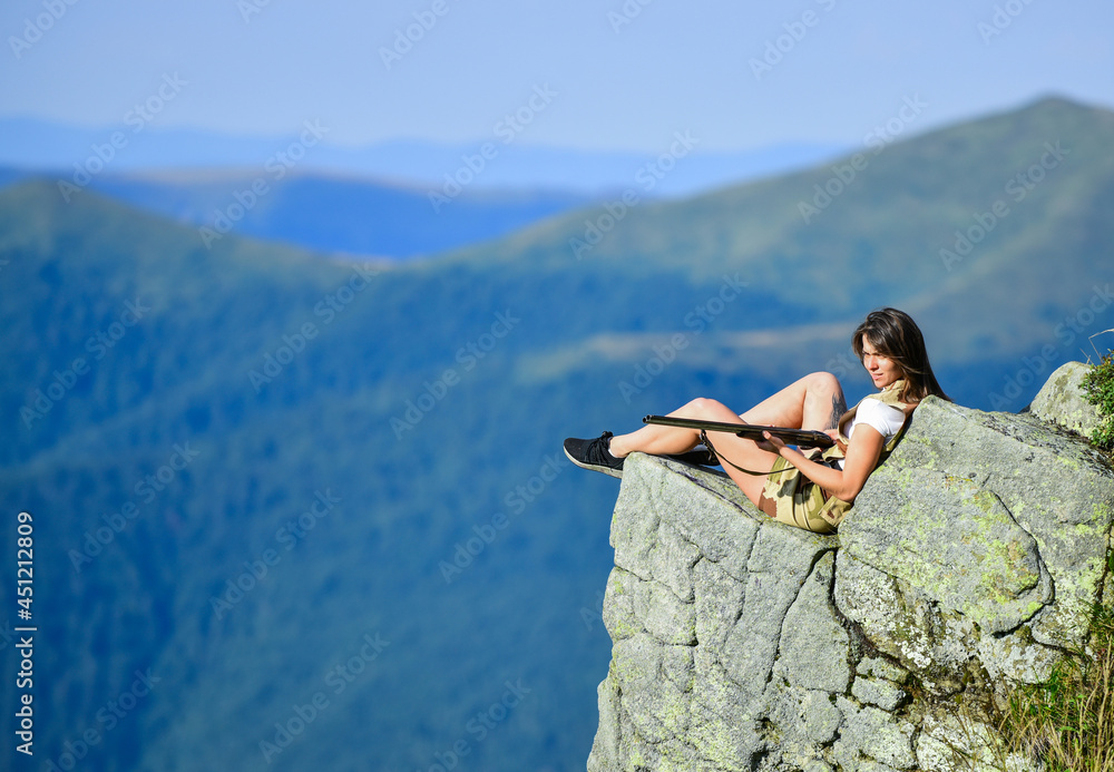 Observing point. Woman military outfit hold weapon highlands background ...