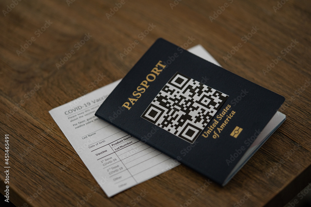 COVID-19 Vaccination Record card next to the Passport with QR Code ...