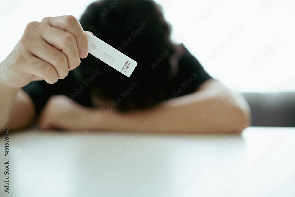 Unhappy Asian young man smashing down on the table after COVID-19 ...