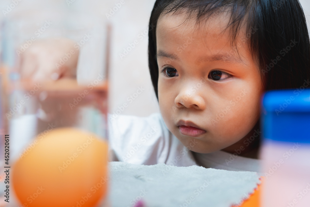 Cute girl doing a simple science experiment, the floating egg ...