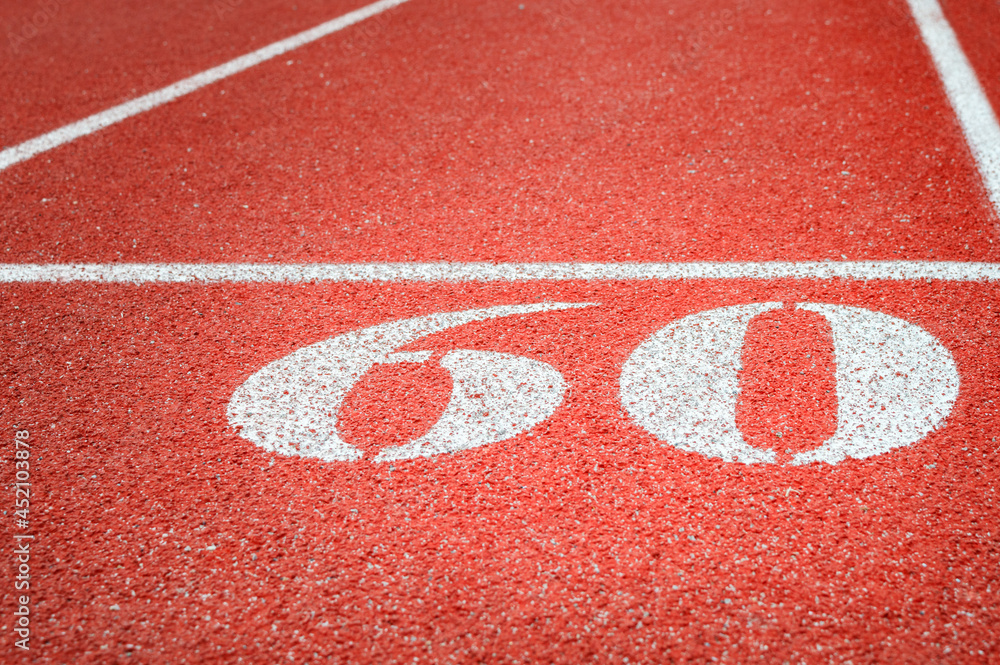 "60" mark on running track. Sign in white numbers and line marked on a ...