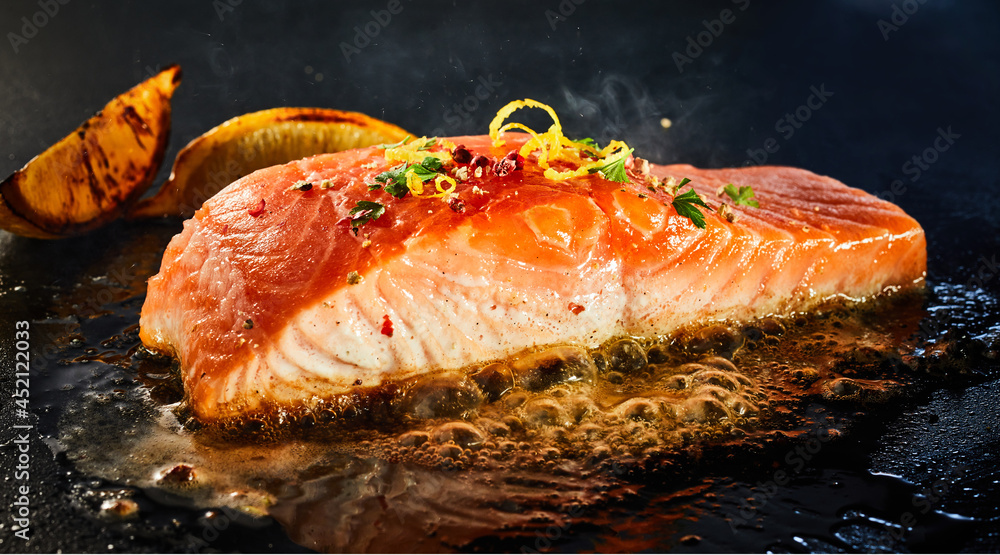 Gourmet cutlet of fresh salmon seasoned with herbs, spices, and lemon ...