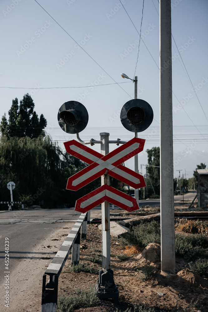 Stop - railway crossing. Crossbuck and stop sign on countryside road ...