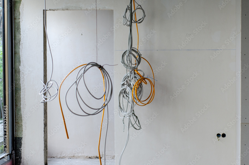 Electric installation work. Pulling wires in an unfinished house Stock ...